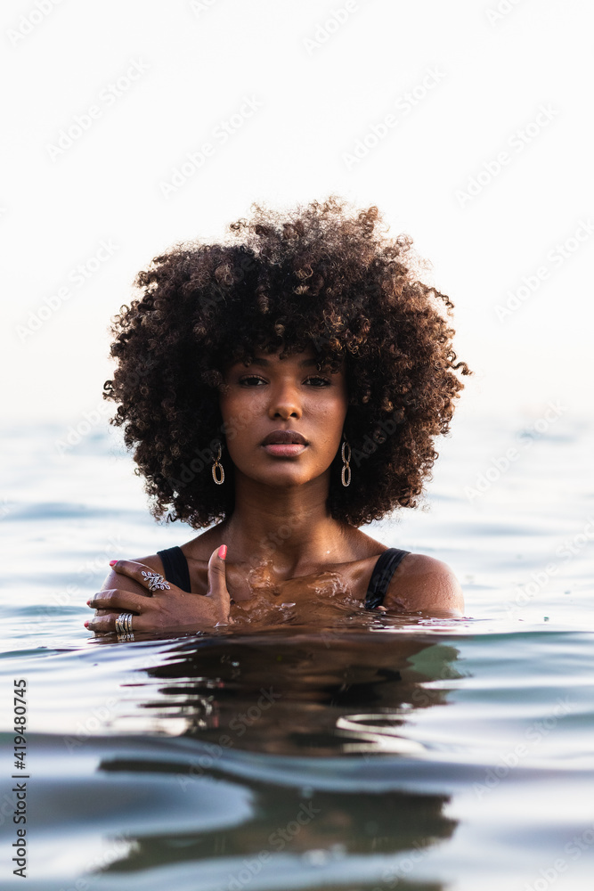 Calm beautiful African American female in bikini and with Afro ...
