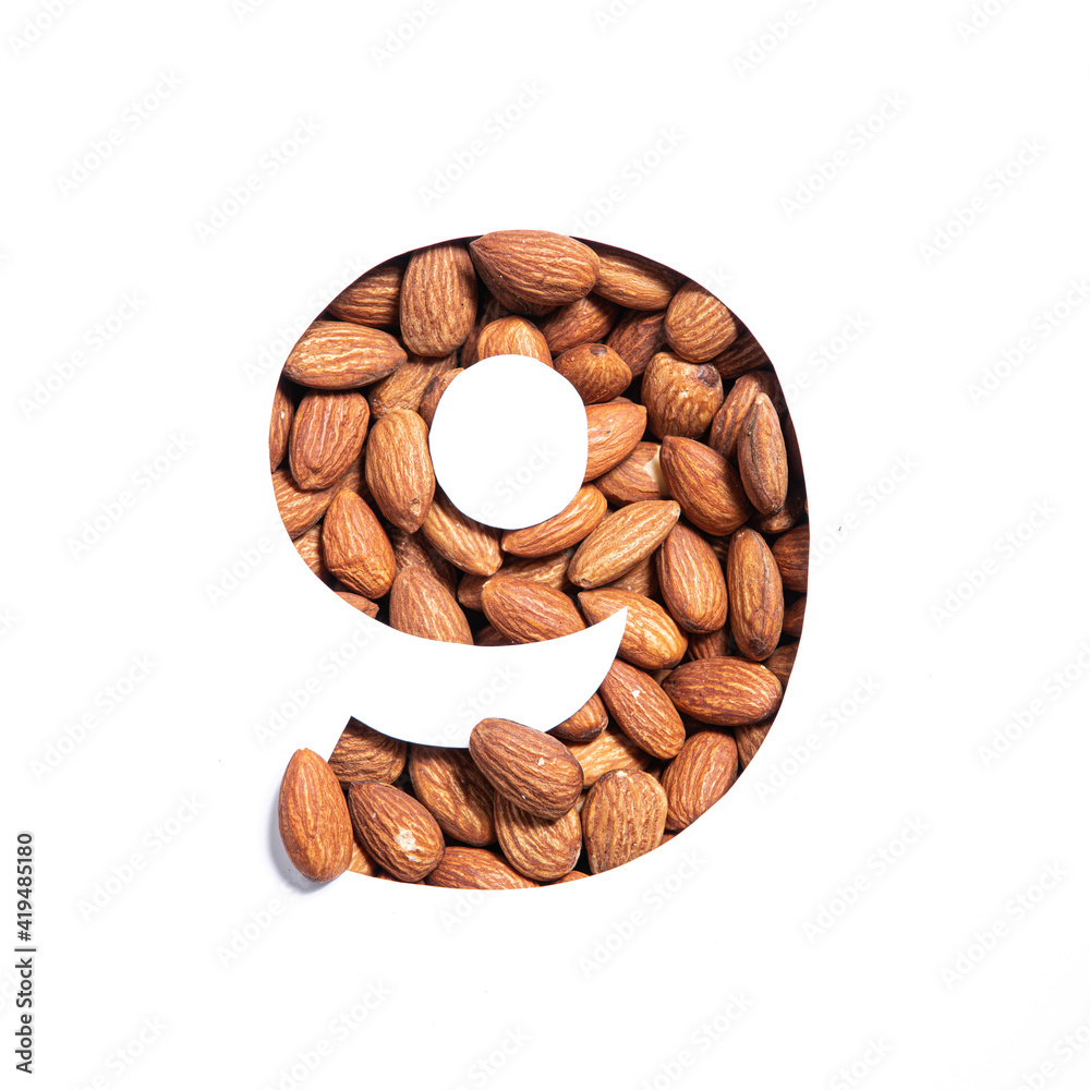 Number nine made of nuts and paper cut in shape of ninth numeral ...