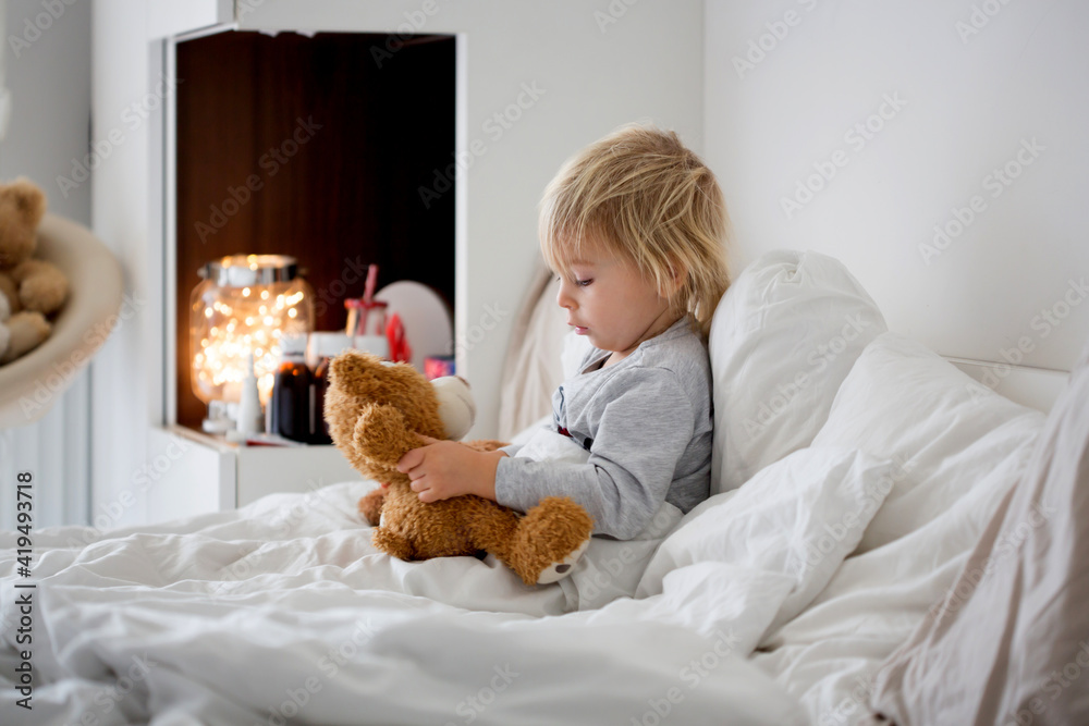 Sick child boy lying in bed with a fever, resting Stock Photo | Adobe Stock