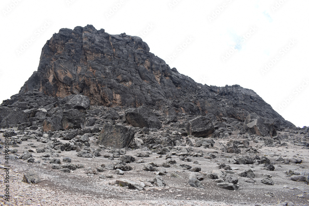 View of the Lava Tower with volcanic boulders scattered in front within ...