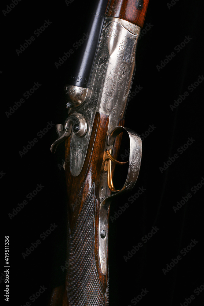 Details of an elegant double-barreled hunting classic shotgun on a ...