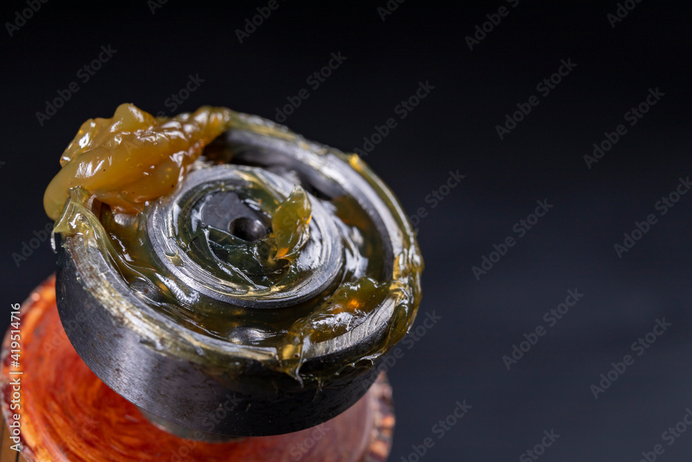 The ball bearing is greased with grease. Assembly work in a mechanical ...