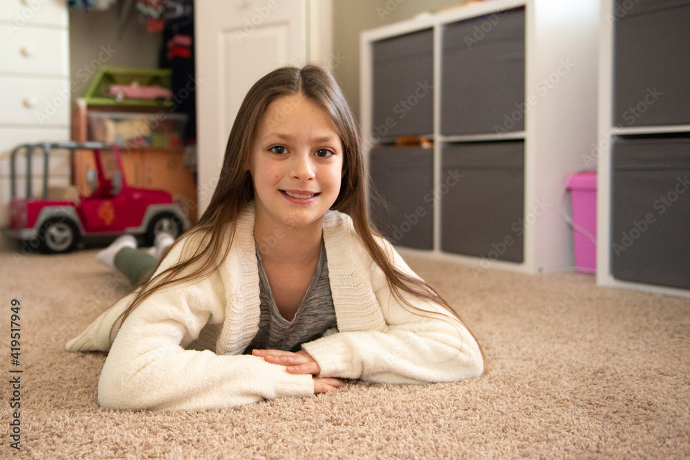 Beautiful tween girl lying on the floor of her bedroom. Stock Photo ...