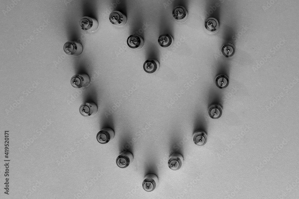 5.56mm bullets arranged in the shape of a heart in black and white ...