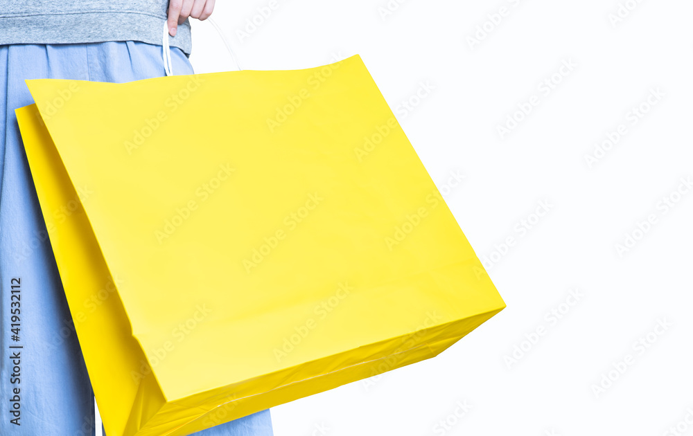 Young person in casual lifestyle carrying a large bright yellow ...