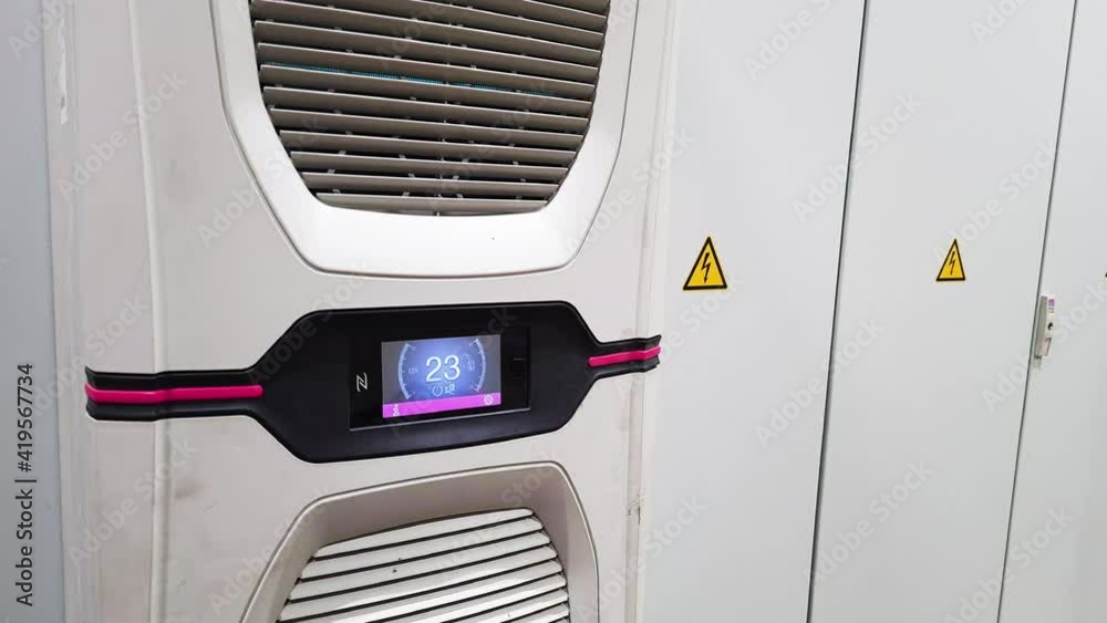 White big industrial conditioner on a door of electric equipment ...