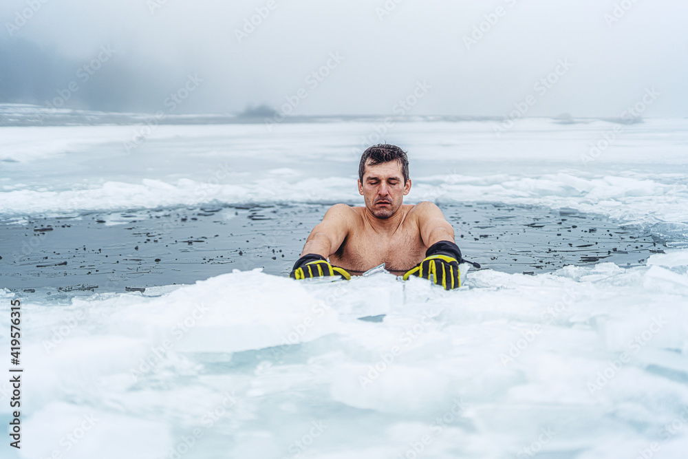 Winter swimming. Man in an ice-hole. Stock Photo | Adobe Stock