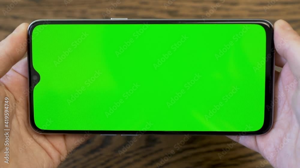 Woman's Hands Hold The Smartphone Horizontally with A Green Screen ...