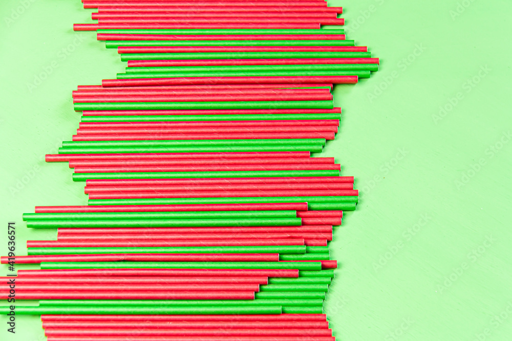 red and green cocktail straws forming a bar chart on green background ...