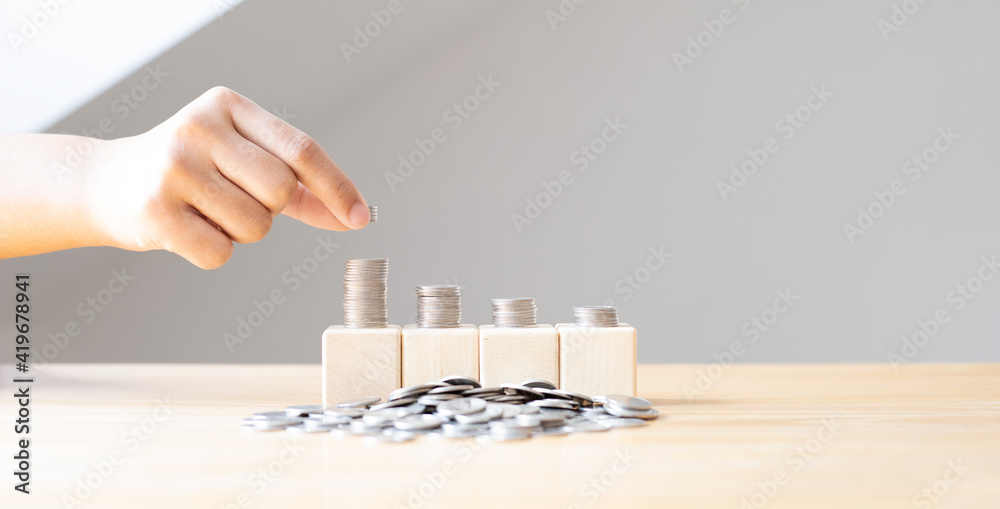 Women are stacking coins on a pile of coins nestled on four rows of ...