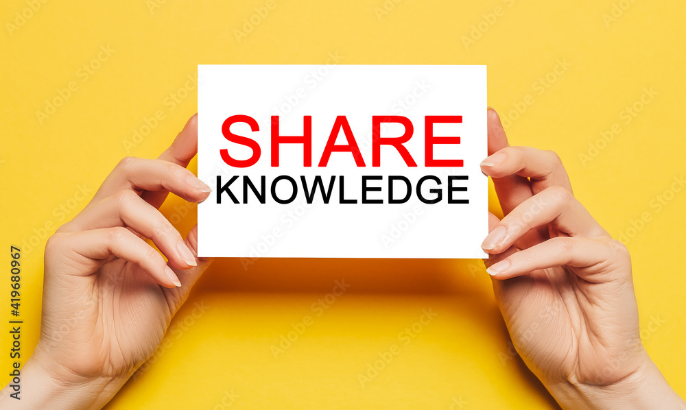 Female hands hold card paper with text SHARE KNOWLEDGE on a yellow ...