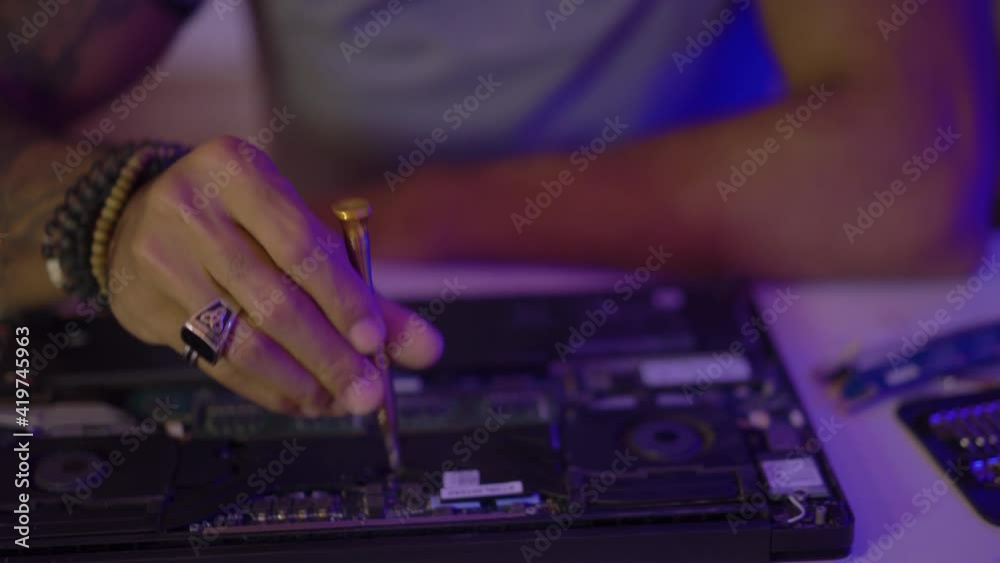 Removing electronic component from the laptop during repair. Repairman ...