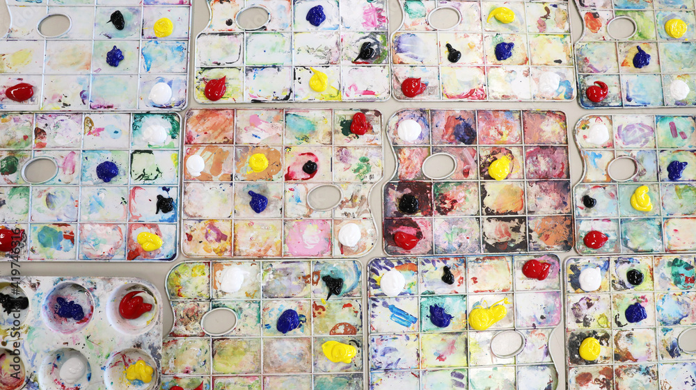 An arrangement of painting palettes set up ready for art class at ...