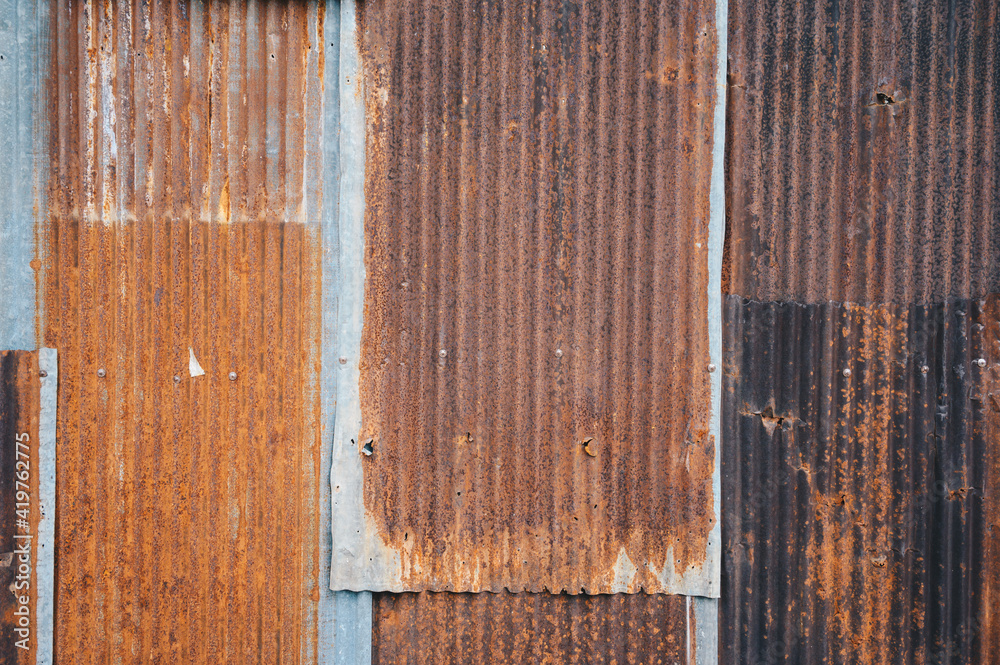 An old rusty metal sheet roof textured. Rust is an iron oxide formed by ...