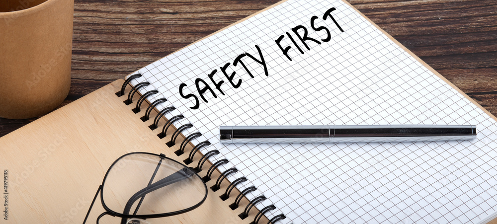 Safety first words written on office notebook. Concept in business ...
