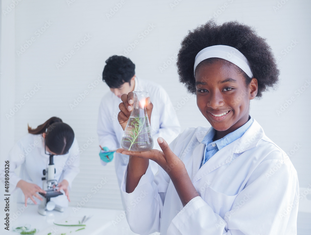 A dark-skinned student smiled happily as she shows the results of the ...