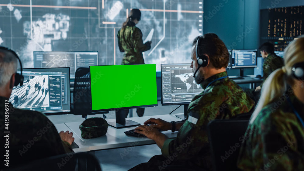 Military Surveillance Officer Working on Computer with Green Screen in ...