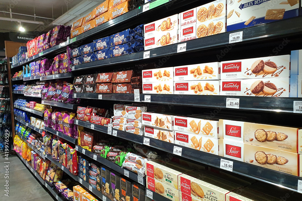 Various brands of local and imported biscuit and cream wafers on store ...