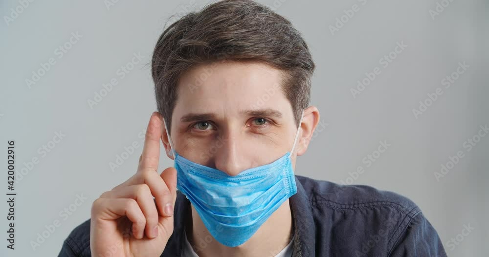 Portrait of caucasian millennial man teaches showing correct wearing of ...