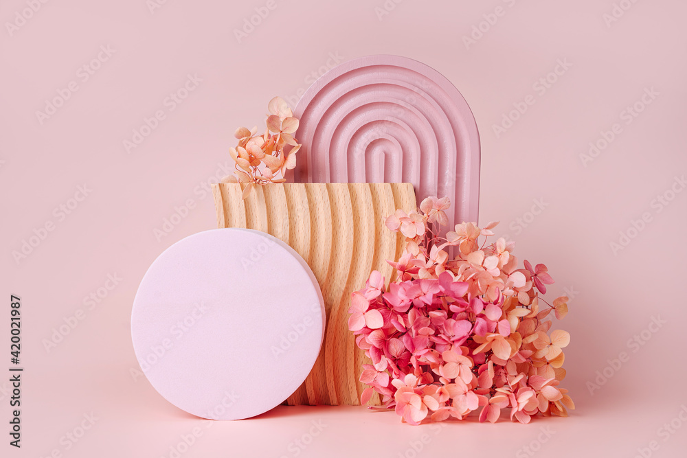 Pink arch, wooden plate with waves and flowers with circle on a pink ...