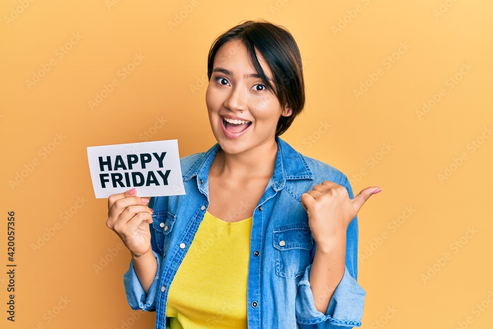Beautiful young woman with short hair holding happy friday message ...