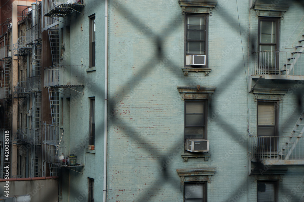 New York City urban apartment buildings viewed behind chain fence Stock ...