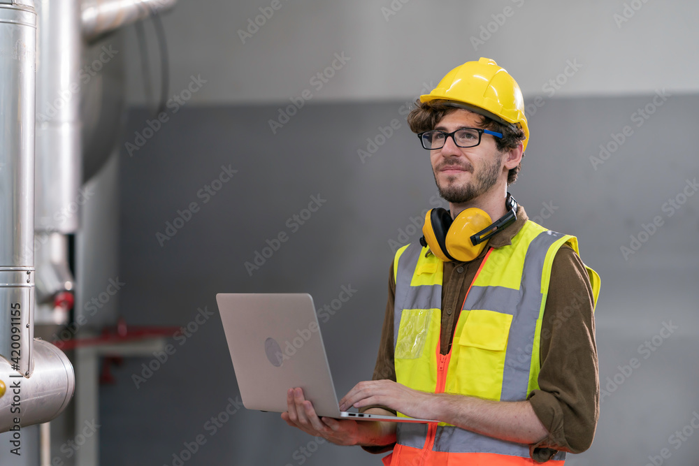 Portrait of HVAC engineer working in boiler room for steam production ...
