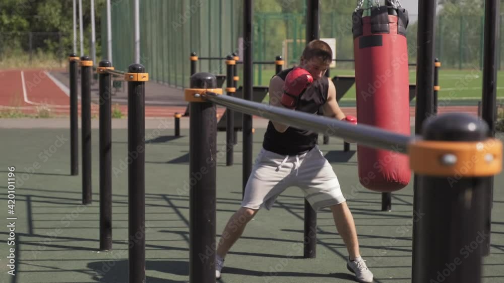 Sequence of shots of young caucasian sportsman training outdoors at ...