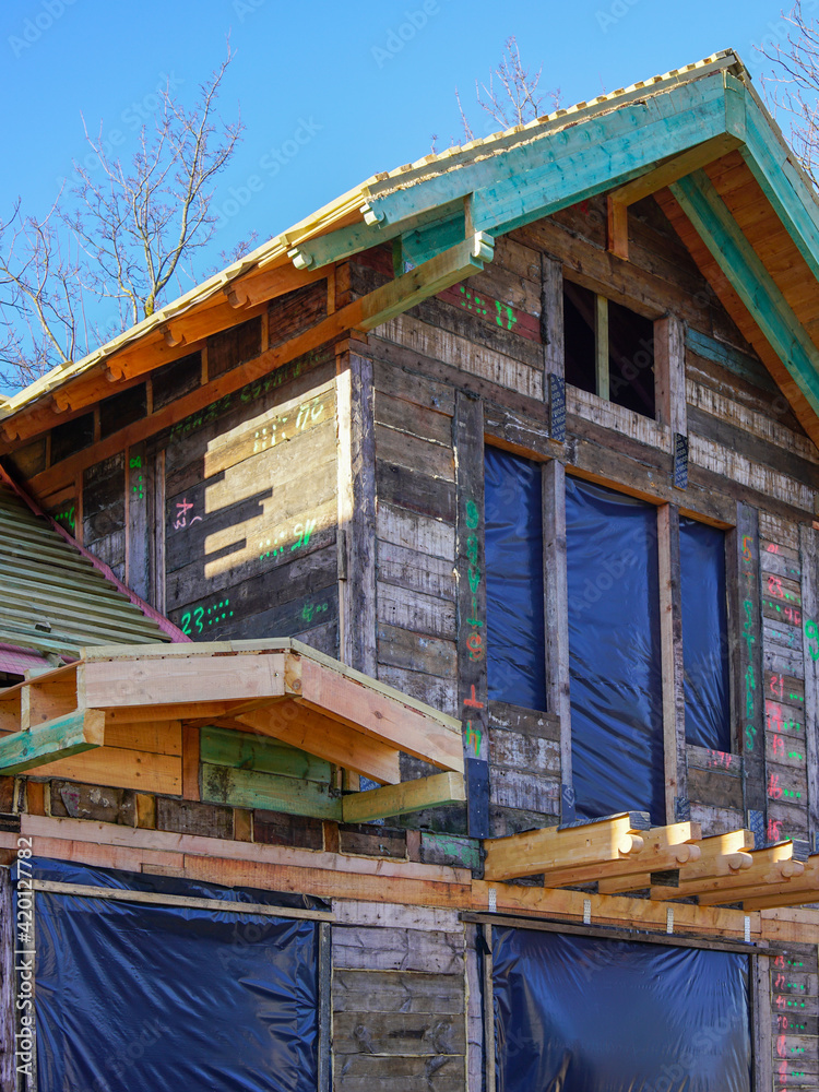 restoration of a wooden house by dismantling, assembling and replacing ...