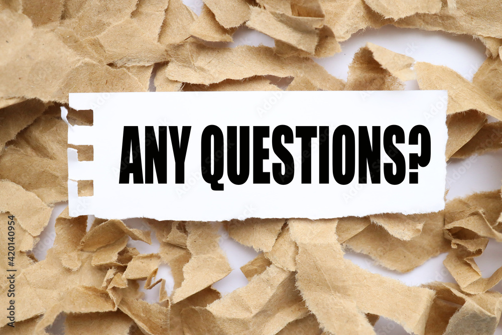 Any questions ? text on white paper over torn paper background. Stock ...