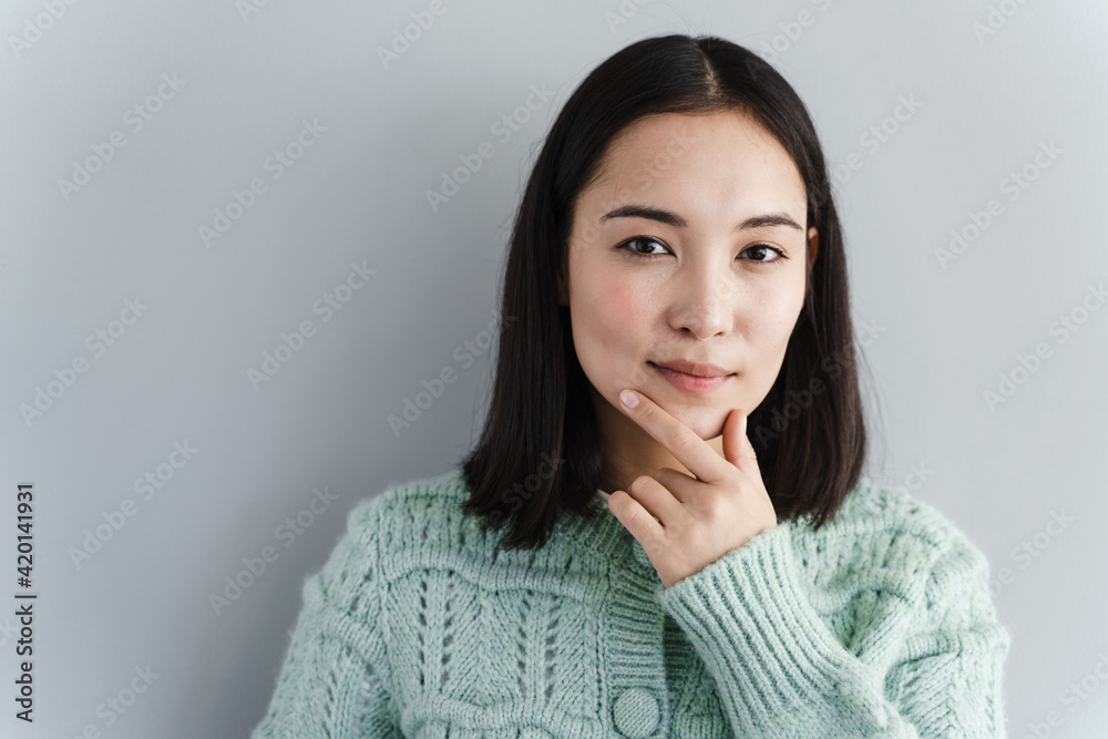 Portrait happy beautiful woman thinking looking up isolated grey wall ...