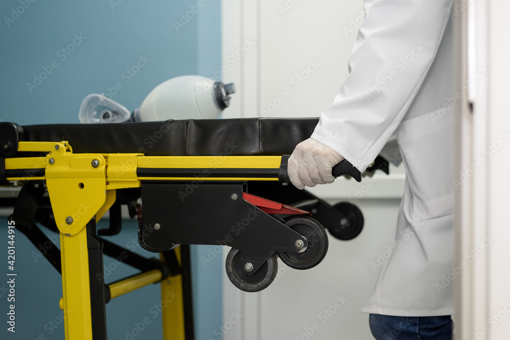 Emergency department in a modern hospital. A doctor or paramedic pushes ...