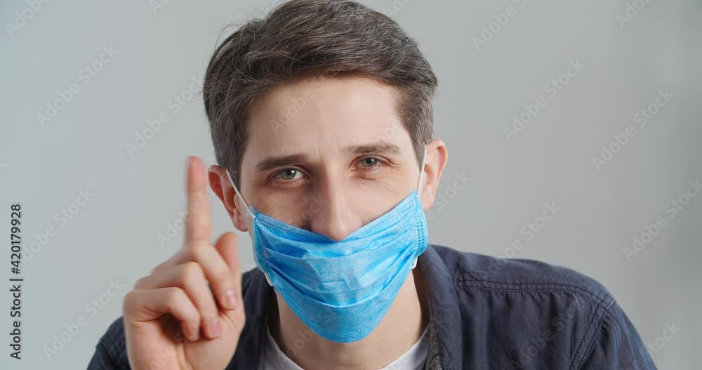 Portrait of young adult caucasian man showing how to properly wear ...