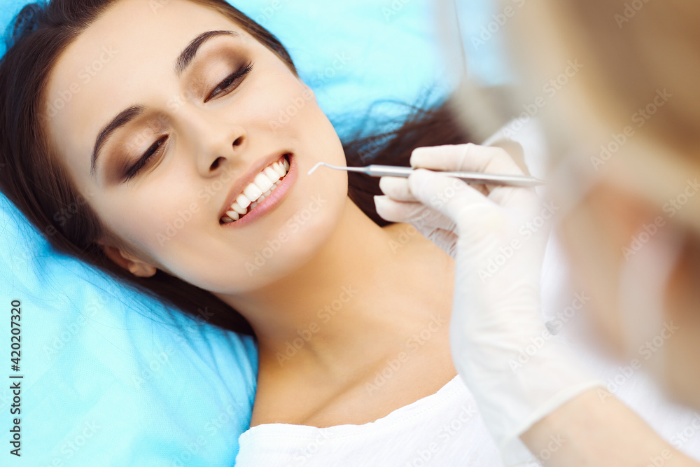 Young female patient visiting dentist office.Beautiful woman with ...