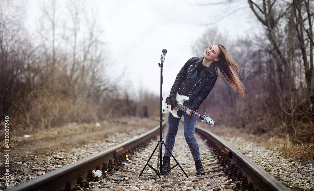 Beautiful young girl rocker with electric guitar. A rock musician girl ...