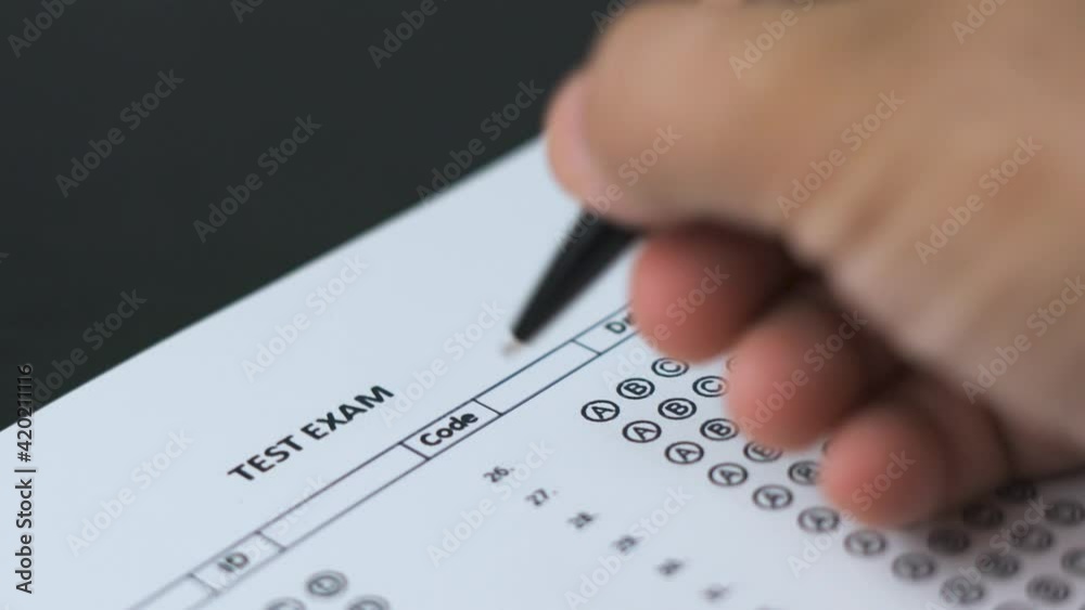 Education and exam concept. Answering multiple-choice test questions. A ...