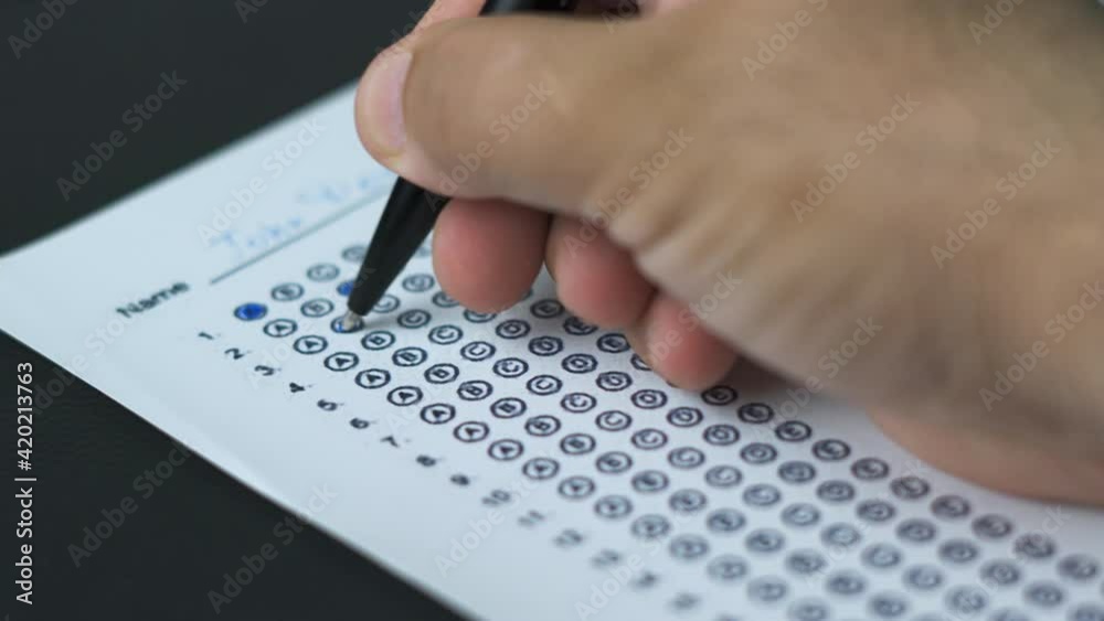 Education and exam concept. Answering multiple-choice test questions. A ...