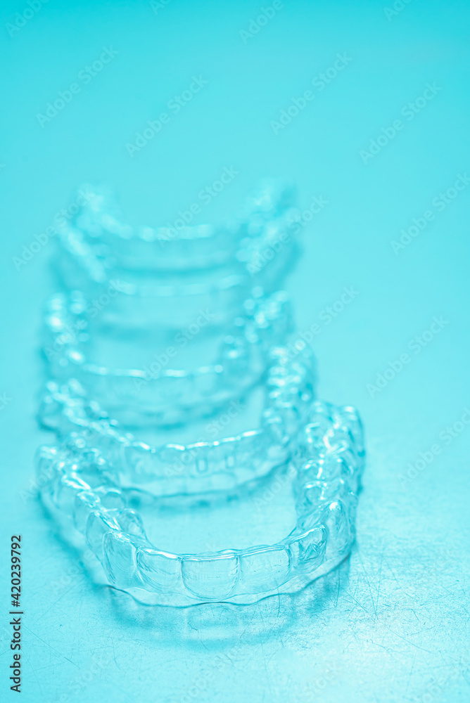 Invisible dental teeth brackets tooth aligners on turquoise background ...