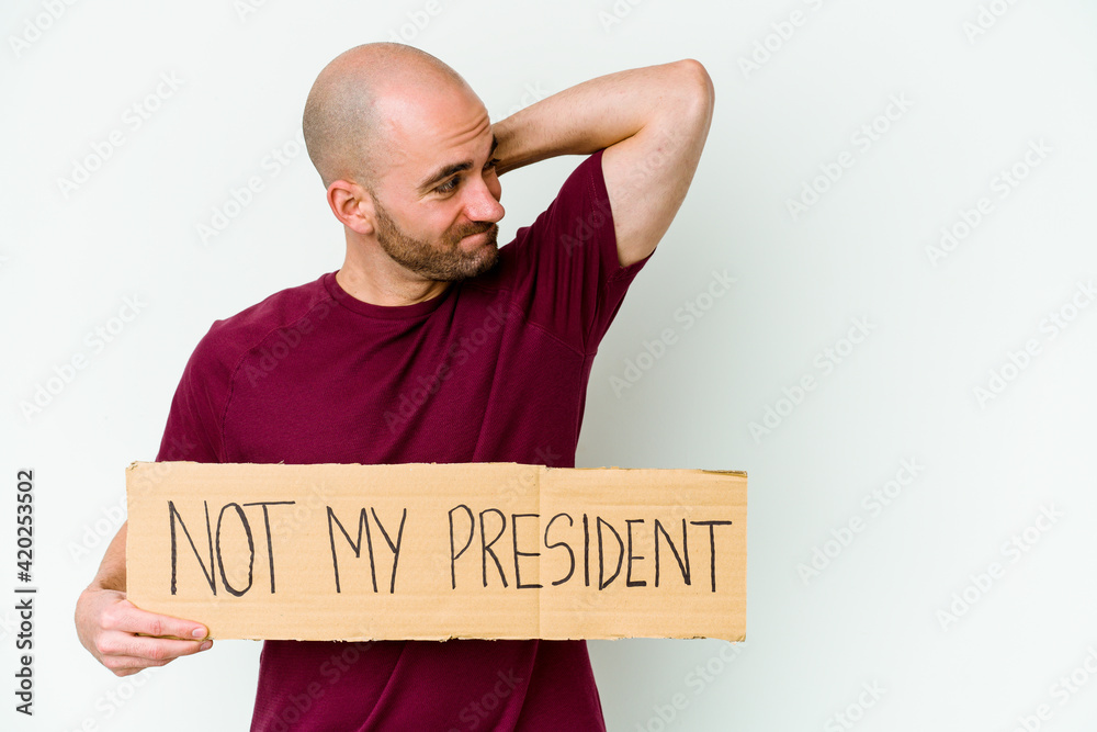Young caucasian bald man holding a Not my president placard isolated on ...