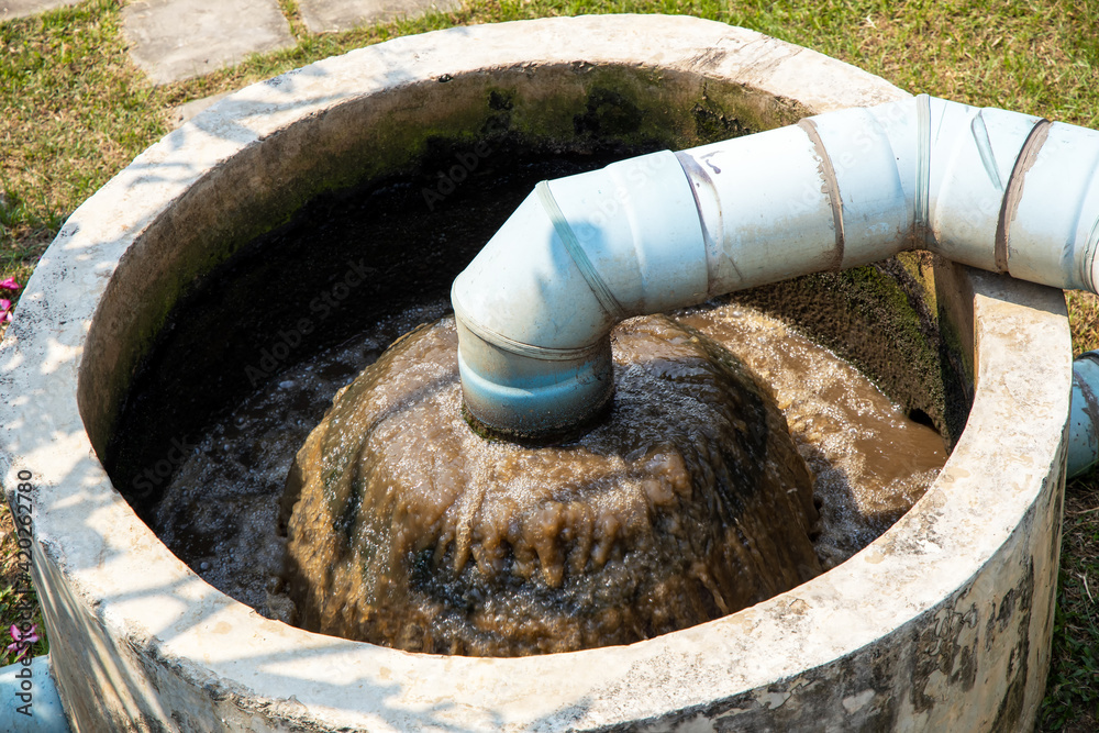 Sewage from drainpipe factory flowing to water treatment tank of waste ...