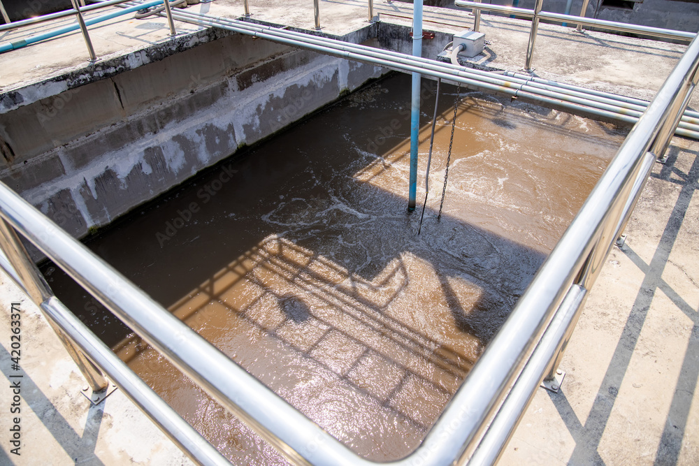 Sewage from drainpipe factory flowing to water treatment tank of waste ...