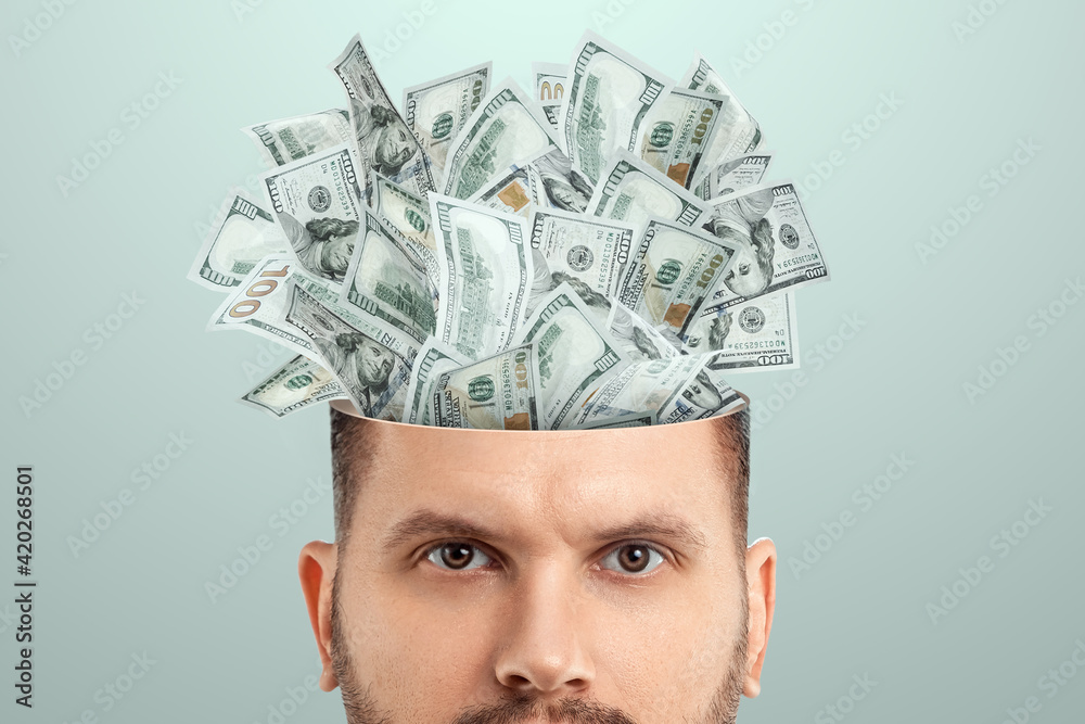 Business thinking, money, dollars sticking out of the mind of a man ...