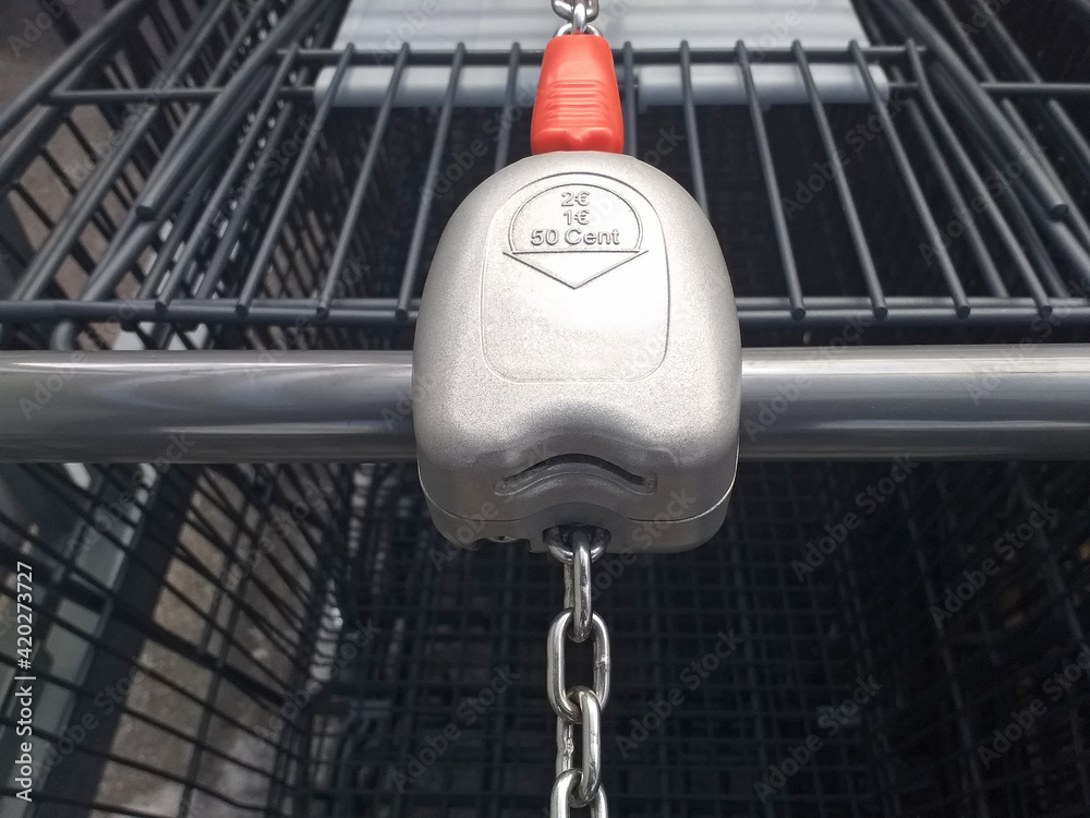 Aerial view of coin lock in shopping cart. Coin release mechanism for ...