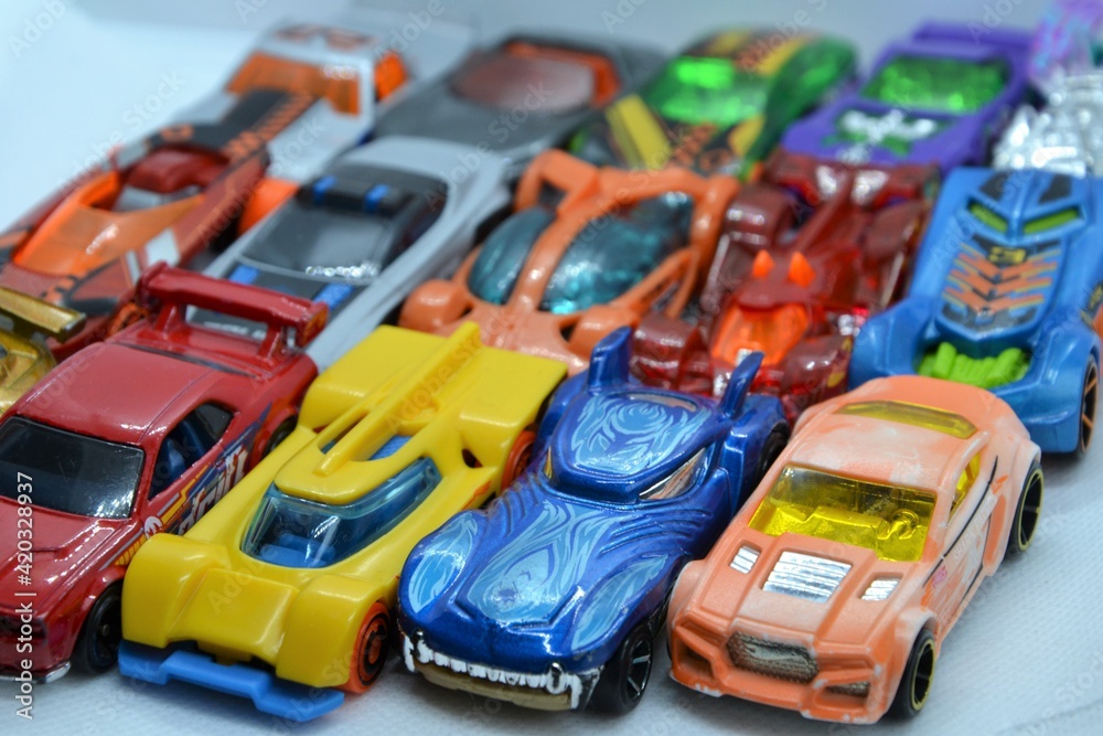 Mix of miniature, colorful toy cars. A lot of little toy car models ...
