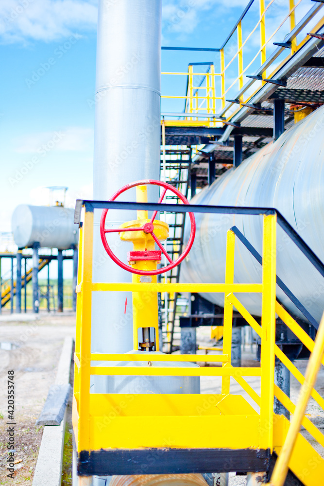 Oil and gas field. Gate valves that control the flow of gas from wells ...