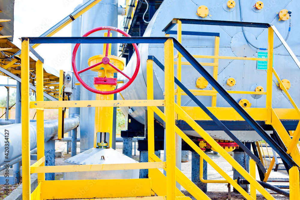 Oil and gas field. Gate valves that control the flow of gas from wells ...