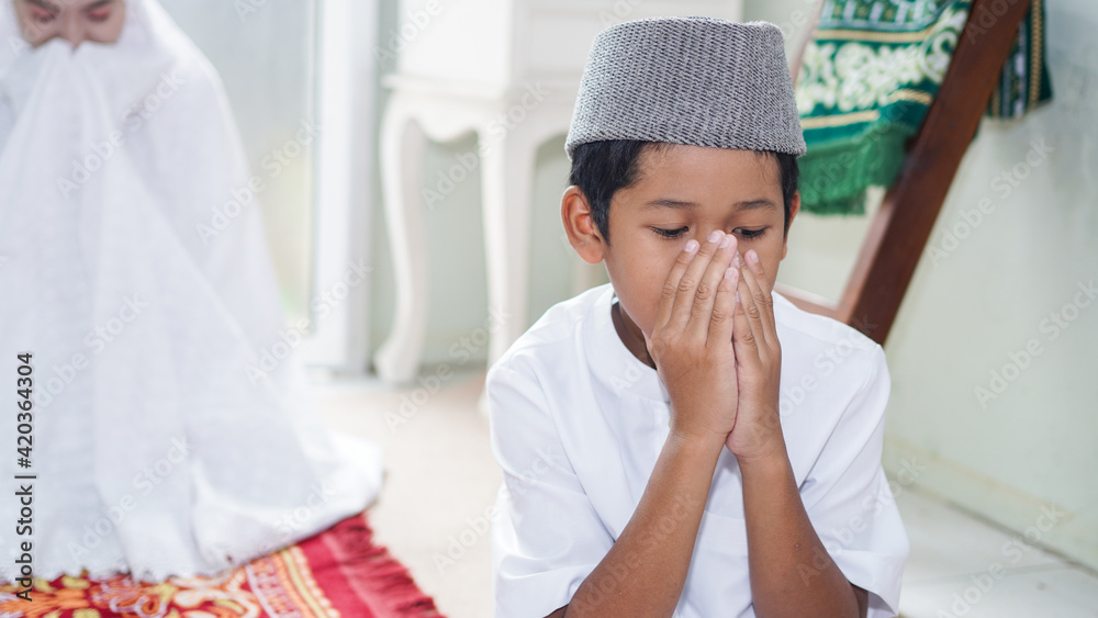 a Muslim family consisting of parents and children perform greeting ...