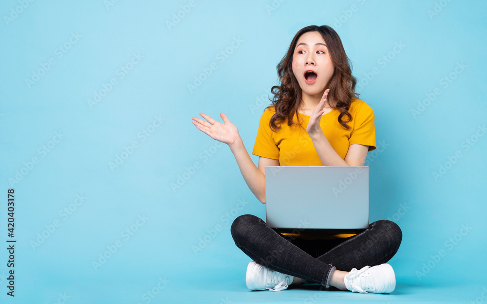 Young girl sitting using laptop with expressions and gestures on ...