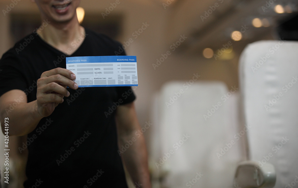 show boarding pass ticket on plane , Hand holding boarding pass and ...