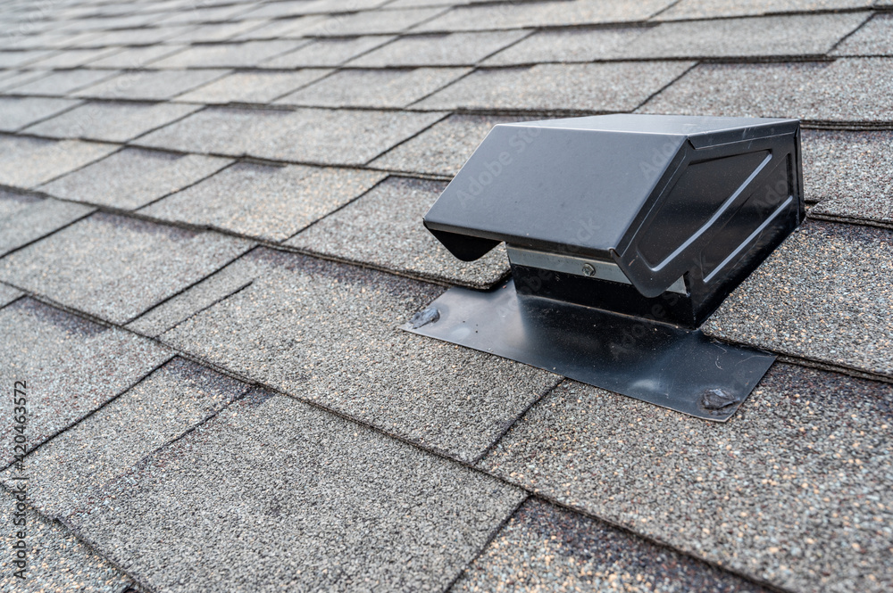 Static vent installed on a shingle roof for passive attic ventilation ...